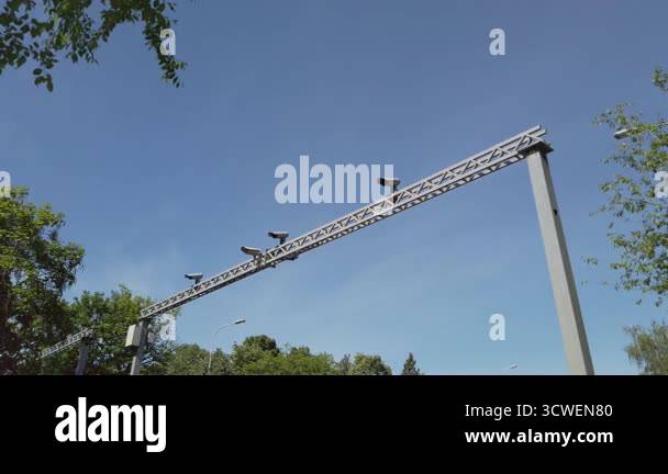 Surveillance cameras are positioned above a busy intersection ...