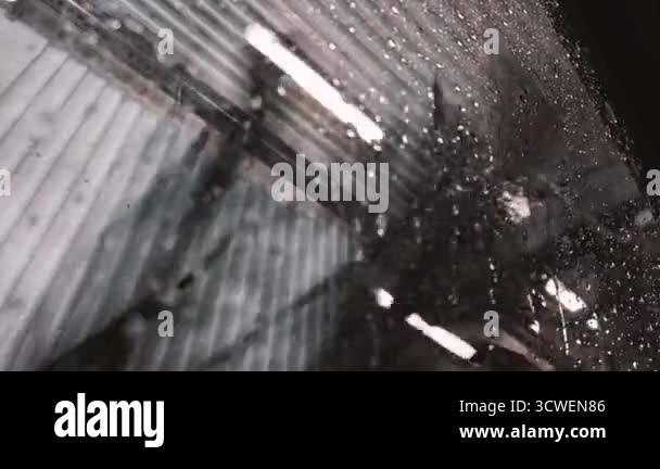 Washing a vehicle with powerful jets sprays and rotating brushes ...