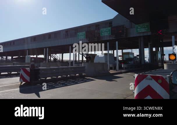 Cars move through a modern toll booth, representing efficient highway ...