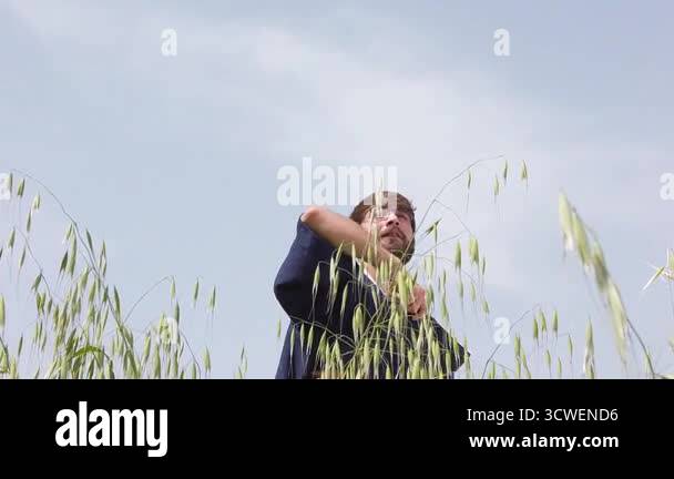 Graduation man alone in a nature against blue sky, throwing the blue ...