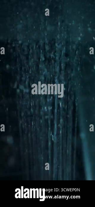 Mesmerizing Water Drops Falling in a Dark Blue Shower Stream, Captured ...