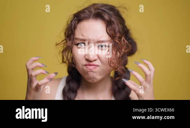 Close-up of a young Kazakh woman showing anger and frustration with ...