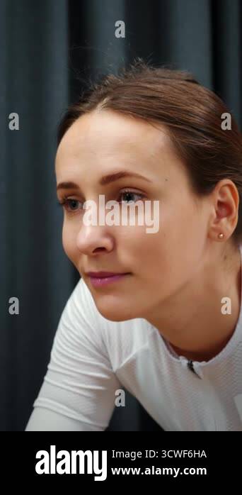 Portrait of female cycling on smart bicycle trainer at home. Woman ...