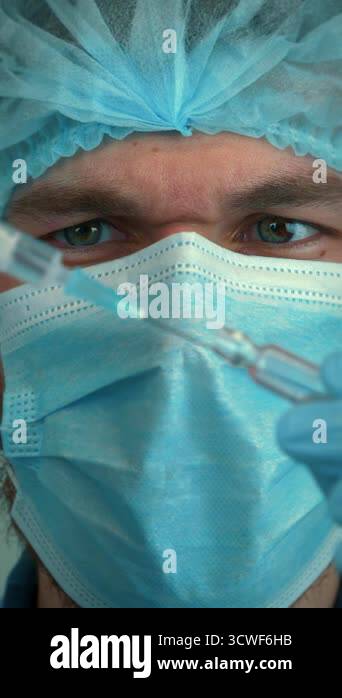 Close up of man in blue medical gloves with syringe with needle testing ...