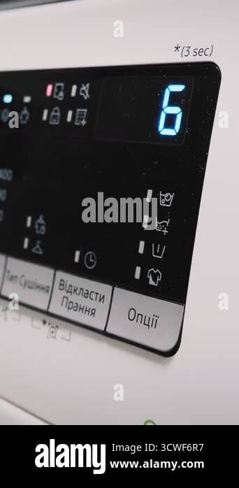 Close up of control panel of working washing machine with options and ...