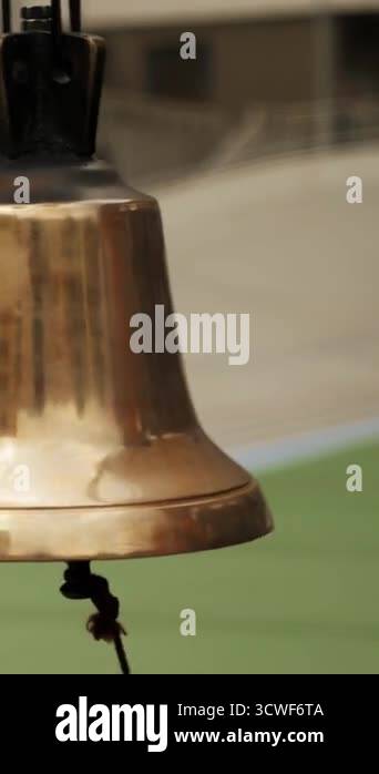Cycling referee rings bell on velodrome during bike race competition, close up of bell. Cycling ...