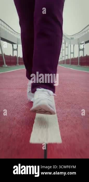 Front follow view of legs of chubby woman running on bridge, doing ...