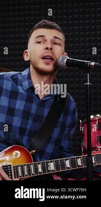 Close up of male artist is singing song. Young handsome man rehearsing ...