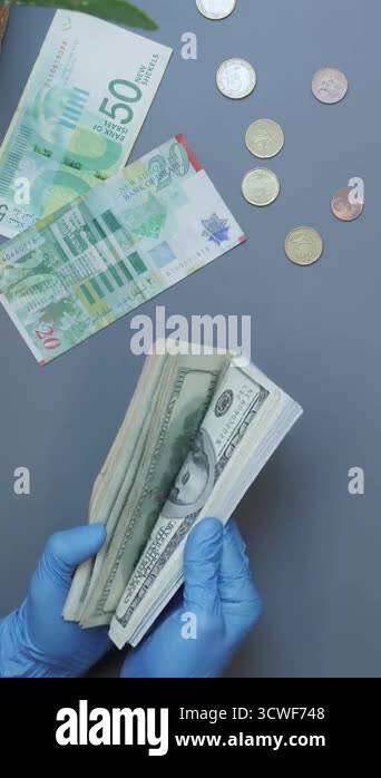 Close up of male hands in blue gloves counting money. Man counts dollar ...
