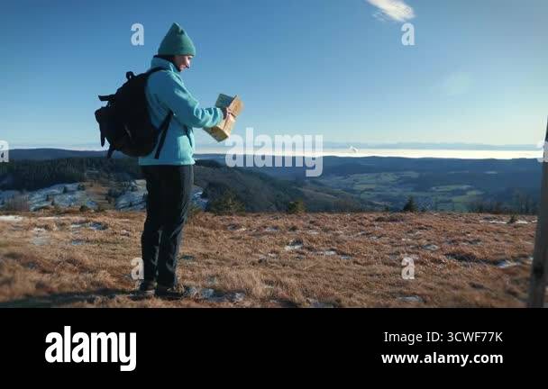 Female explorer in tourist outdoors clothes with backpack and map in ...