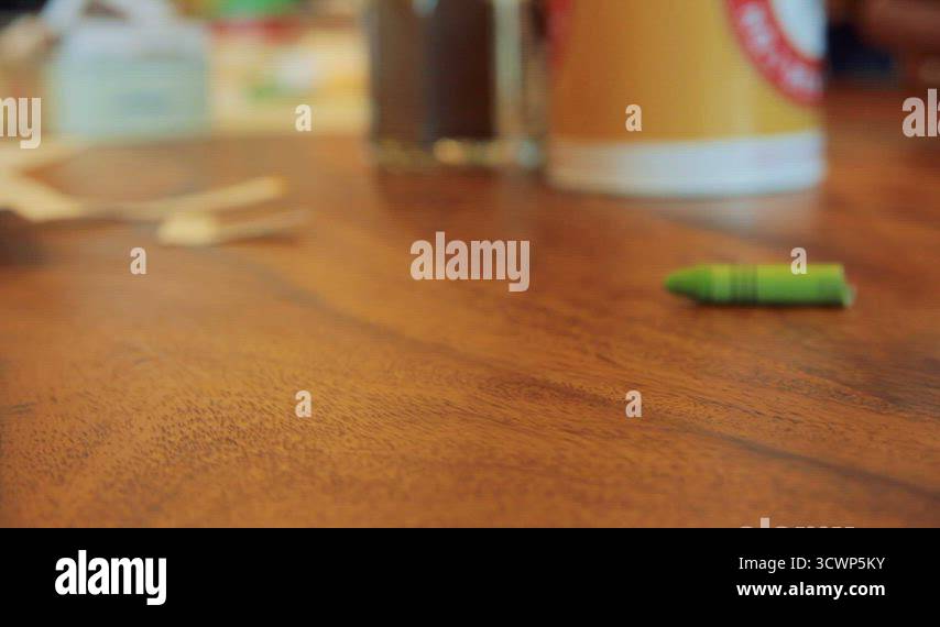 Green color pastel crayon rolls on brown wooden table Stock Video ...