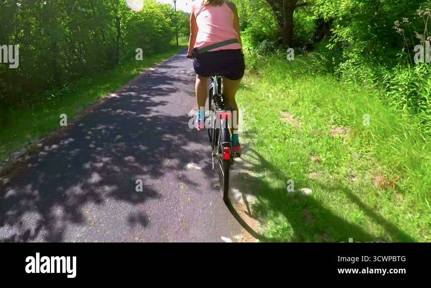 Pretty girl biking on Balaton bike trail near the Lake Balaton of ...