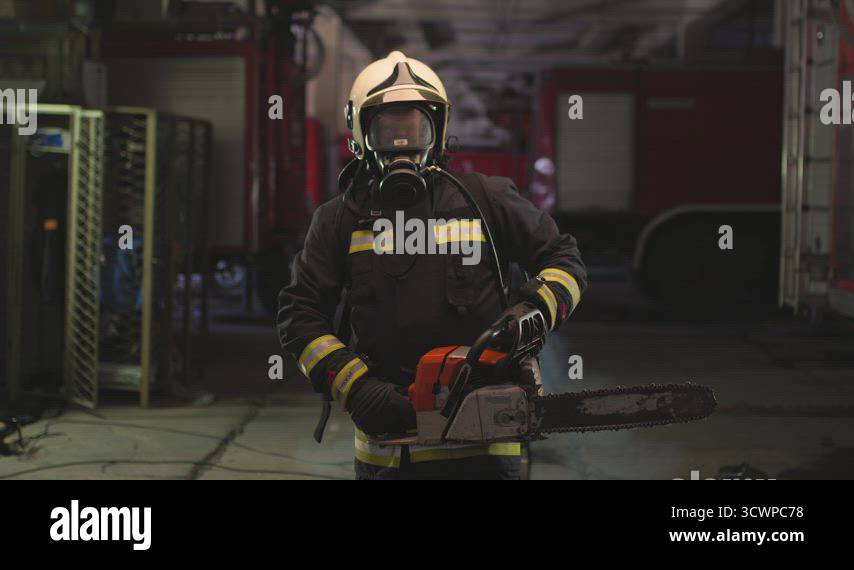 Firefighter portrait wearing full equipment, oxygen mask, and chain saw ...