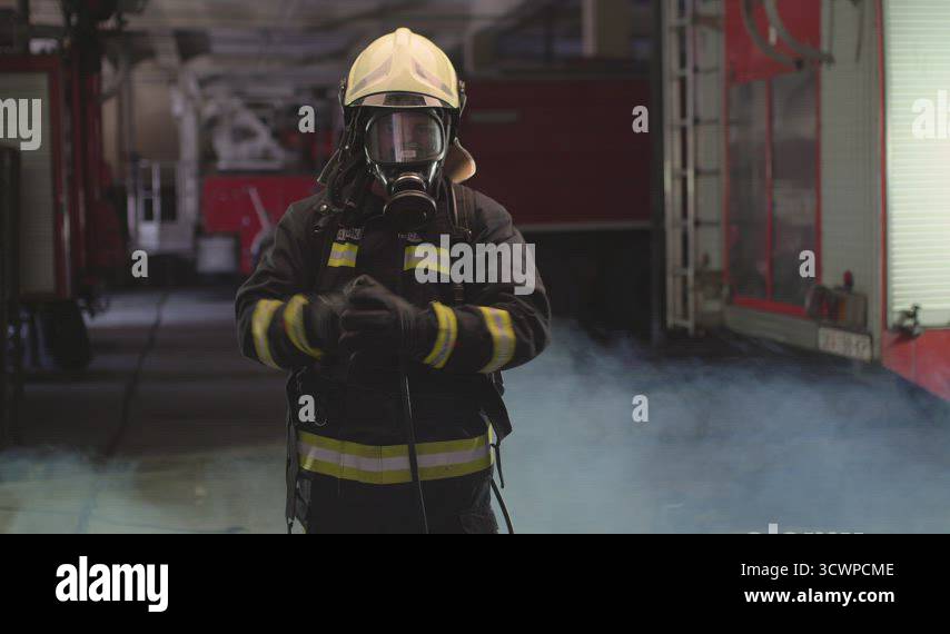 Firefighter portrait wearing full equipment. Putting on oxygen mask ...