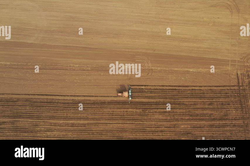 Above view of working traktor on spring field, agriculture machinery ...
