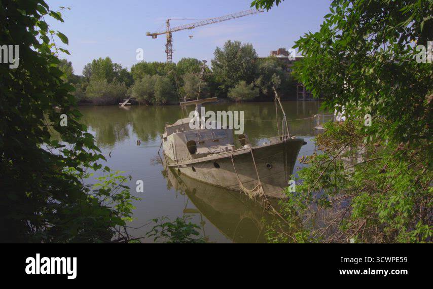 old ruined boat sunk near the shore of river Danube, in Novi Sad ...