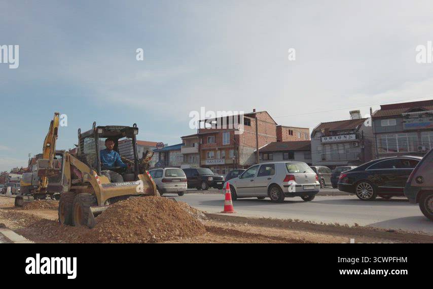 Excavators working on a street, building an extra lane. Road expansions ...