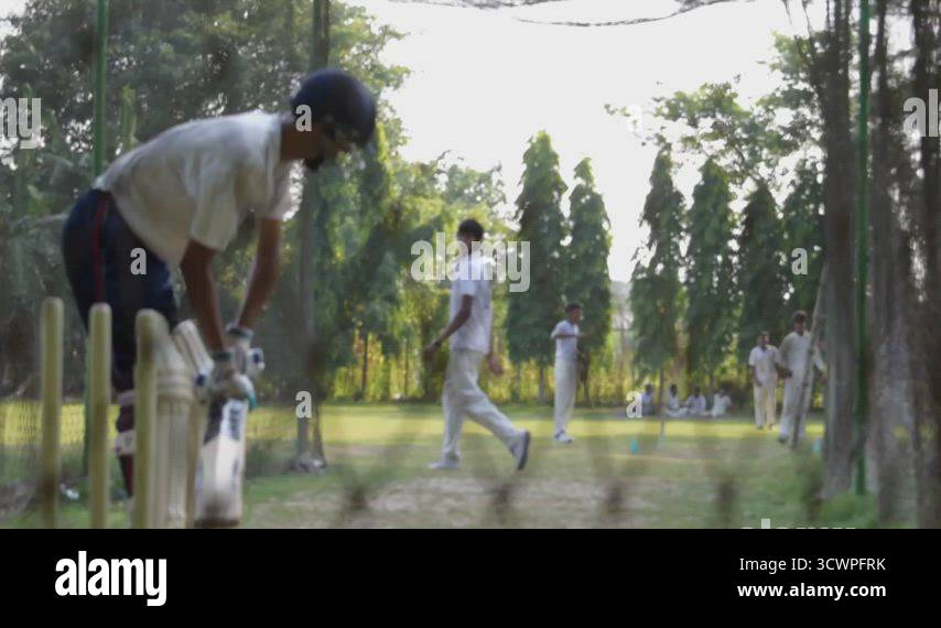 Cricket player in sports uniform Batting bowling in Nets Sessions for both batsman and bowlers ...