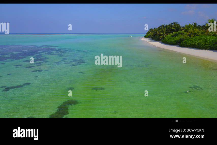 A beautiful view of a white beach in a small remote island with palm ...