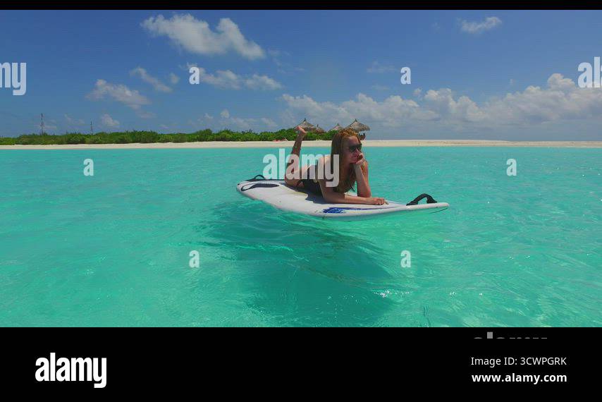 A beautiful caucasian girl in bikini sunbathing and relaxing on a ...