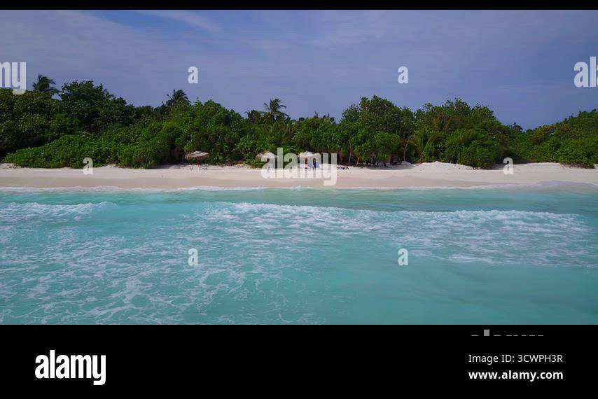 Beautiful scenery of a unspoiled beach with small beach huts, crystal ...
