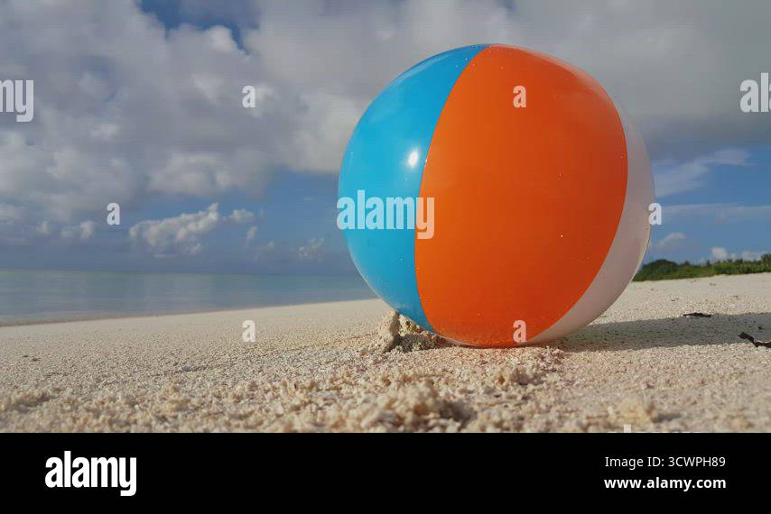 Rainbow beach ball on the sand in a beach in Hawaii Stock Video Footage ...