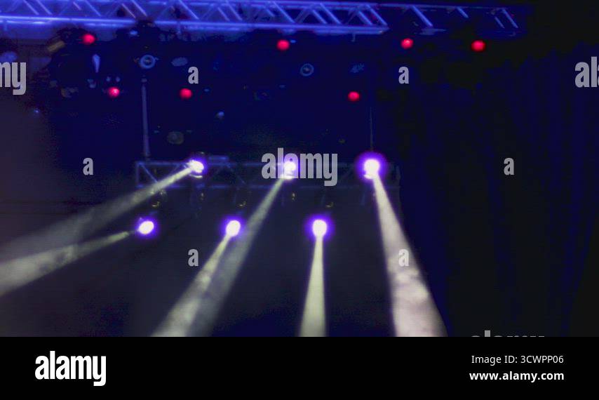 Flashing light beams from stage lights on a construction Stock Video ...