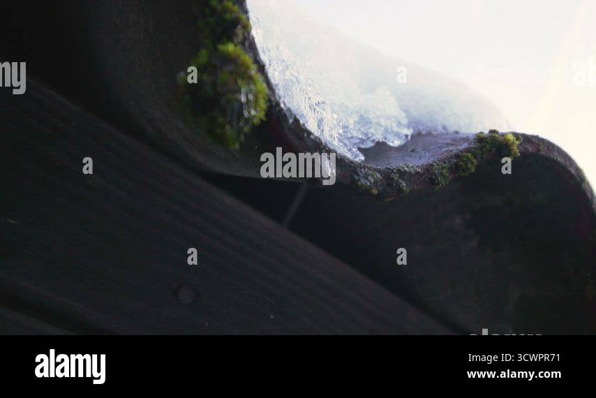 snow melting from an old roof, slowmotion footage Stock Video Footage ...