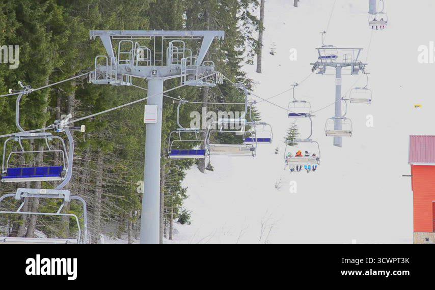 ski resort, chair ski lift elevator lifting people on the mountain ski ...