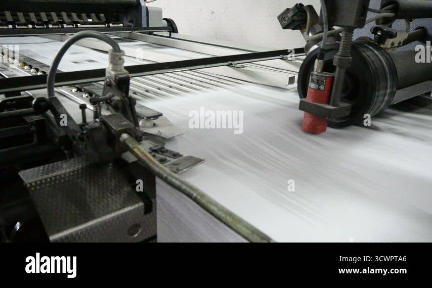 folding machine folds printed offset sheet as part of newspaper ...