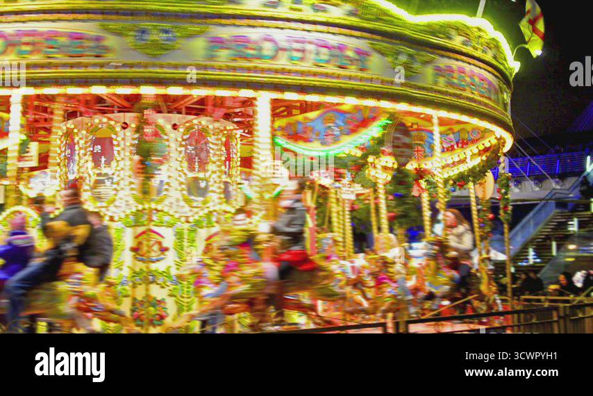 medium shoot of carousel turning around illuminated at night in london ...