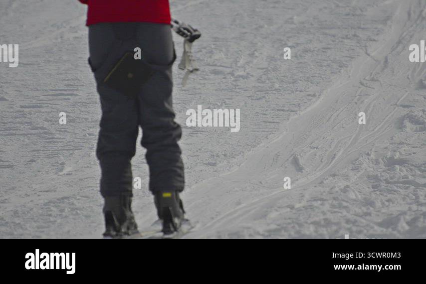 panning shoot of ski lift pulling skier on the top of skislope Stock ...