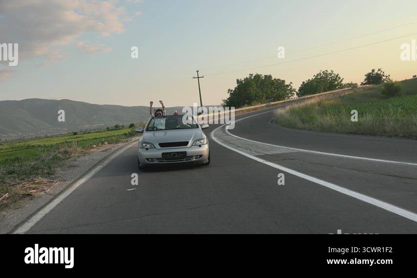 Couple driving convertible car cabriolet steadicam tracking shot. UHD ...