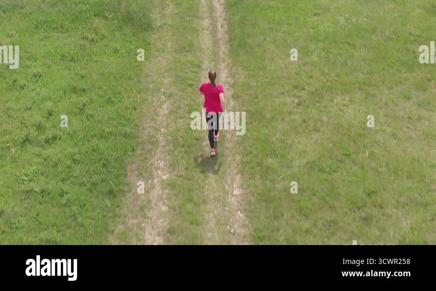 Sporty teenager running on meadow, aerial footage Stock Video Footage ...