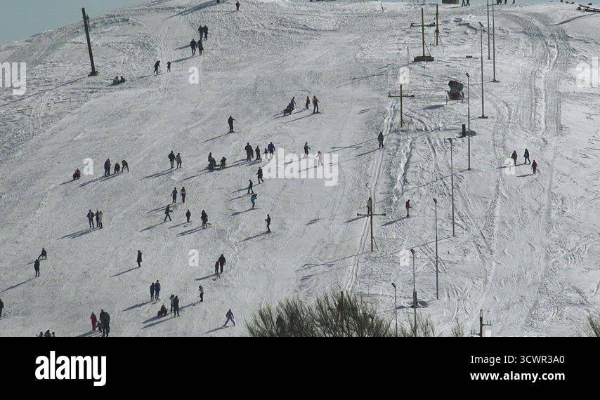 4K Skiers at the ski slope mountain top, snowy peaks of the Alps. UHD ...
