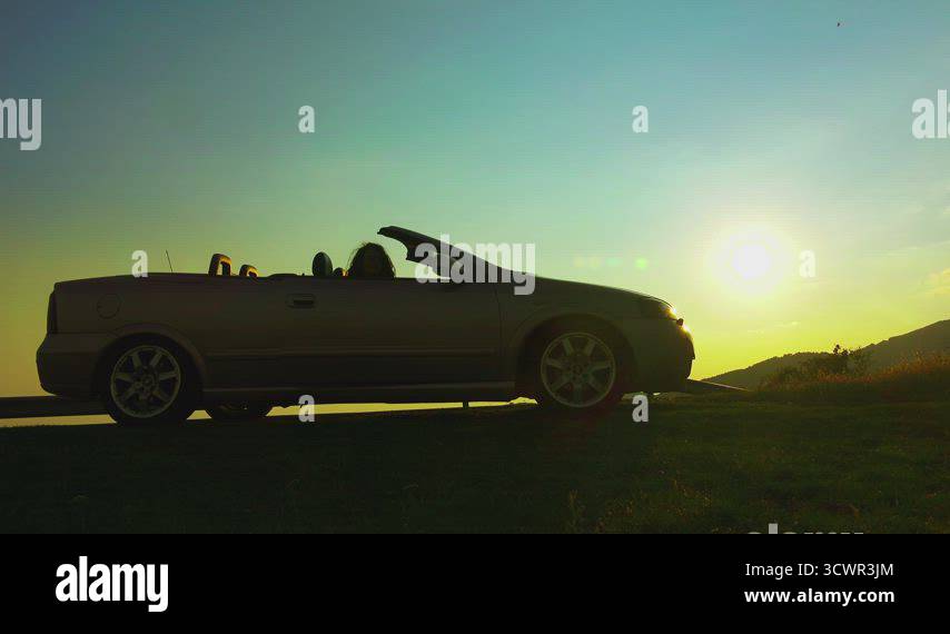 Romantic couple silhouette and convertible cabriolet car enjoy summer ...