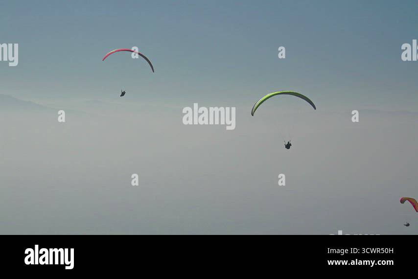 Floating in space, paragliders moves smoothly through the air, floating ...