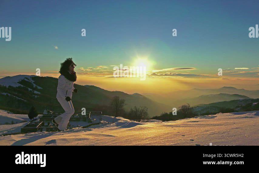 4k runner girl running uphill exercise. winter snow sunset mountain top ...
