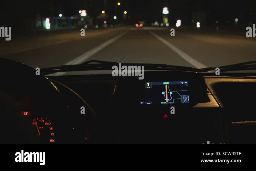 Car driving on highway at night with illuminated dashboard and ...