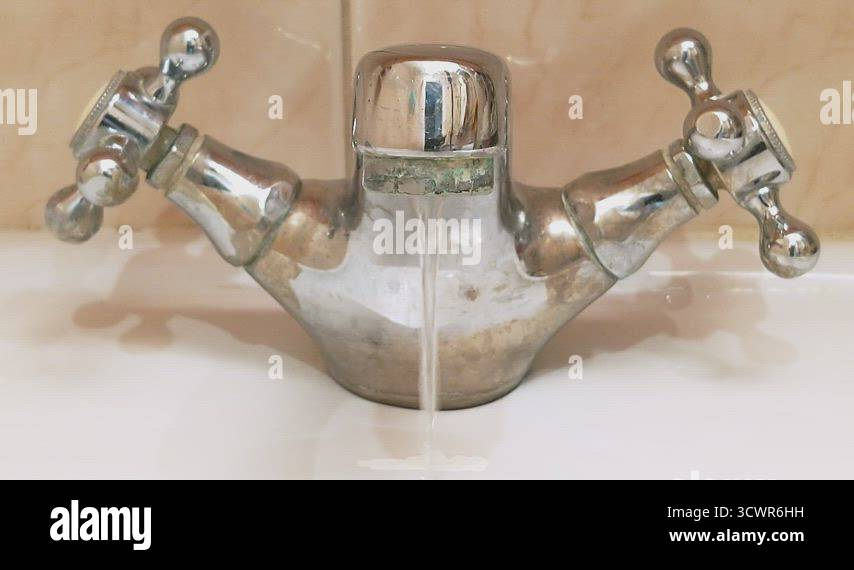 Tap with Water Flowing Slowly Stock Video Footage - Alamy
