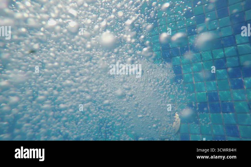 underwater bubbles from pool water jet filling hose, thermal spa pool ...