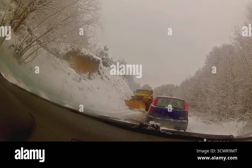 Snow blower removing snow from mountain road. Large vehicle pushes ice ...