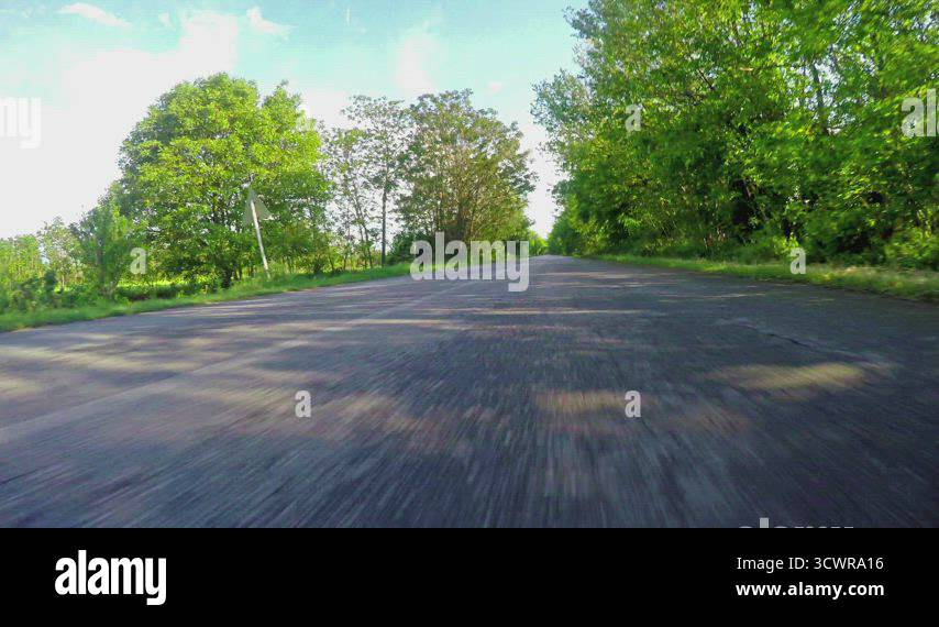 Driving a car on a country road timelapse. Front Wheel spinning POV ...