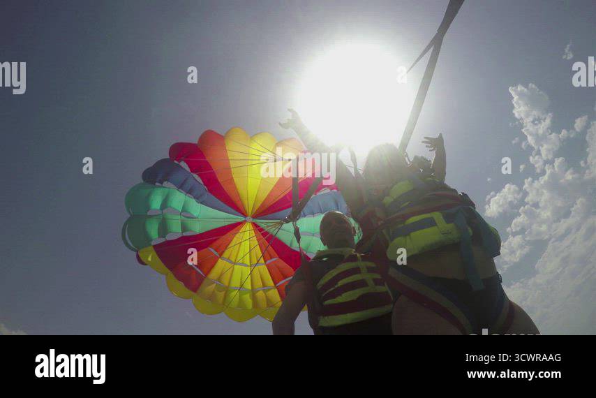 4k Two duplex paragliders paragliding under sun Stock Video Footage - Alamy