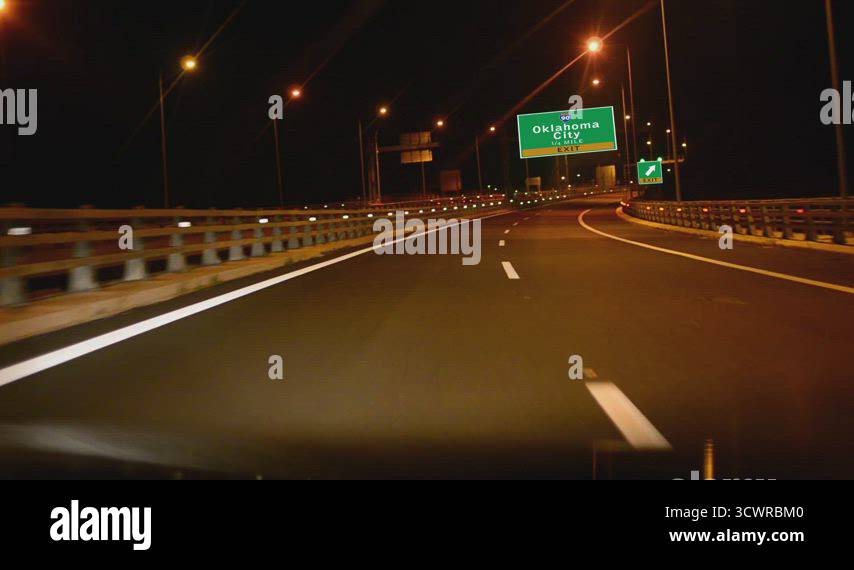 Driving on Highway/interstate at night, Exit sign of the Oklahoma Ciry ...