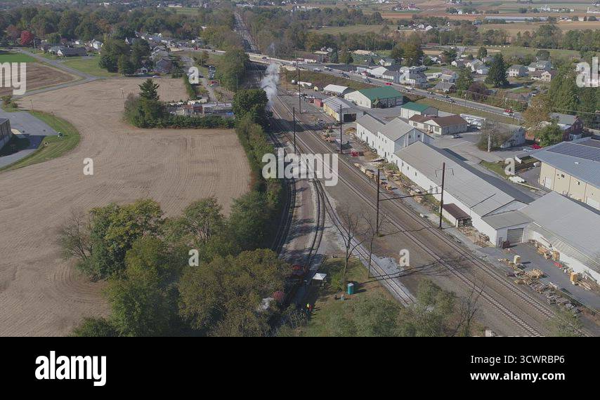 Aerial view of an antique restored steam locomotives moving around in a ...