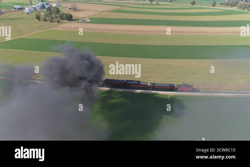 Aerial view of an antique restored steam locomotive backing up in the ...