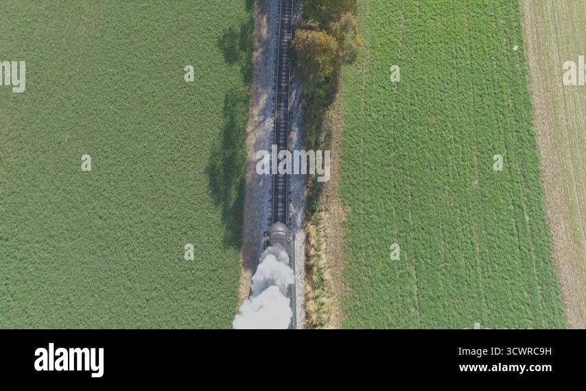Aerial over head view of an antique restored steam locomotive traveling ...