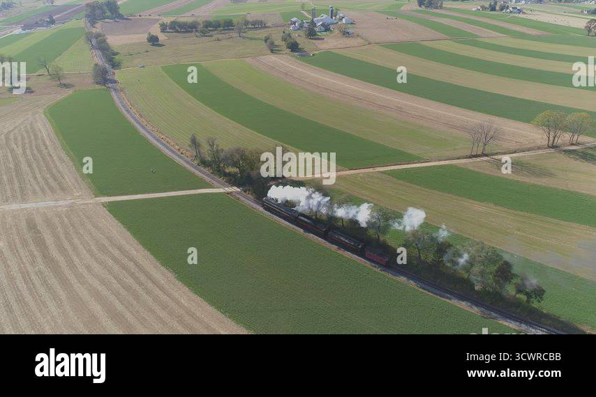 Aerial over head view of an antique restored steam locomotive traveling ...