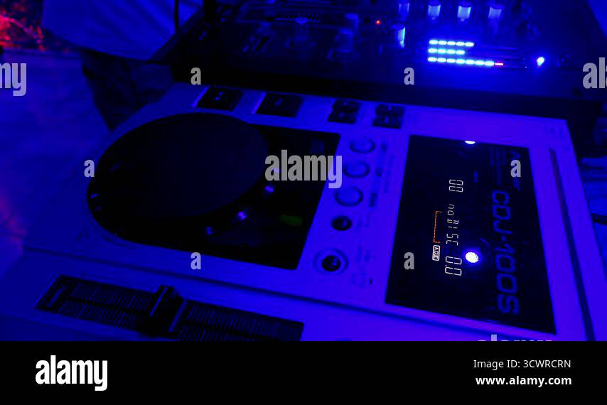 Hands of DJ which mixes music tracks with CD-players and mixer in ...